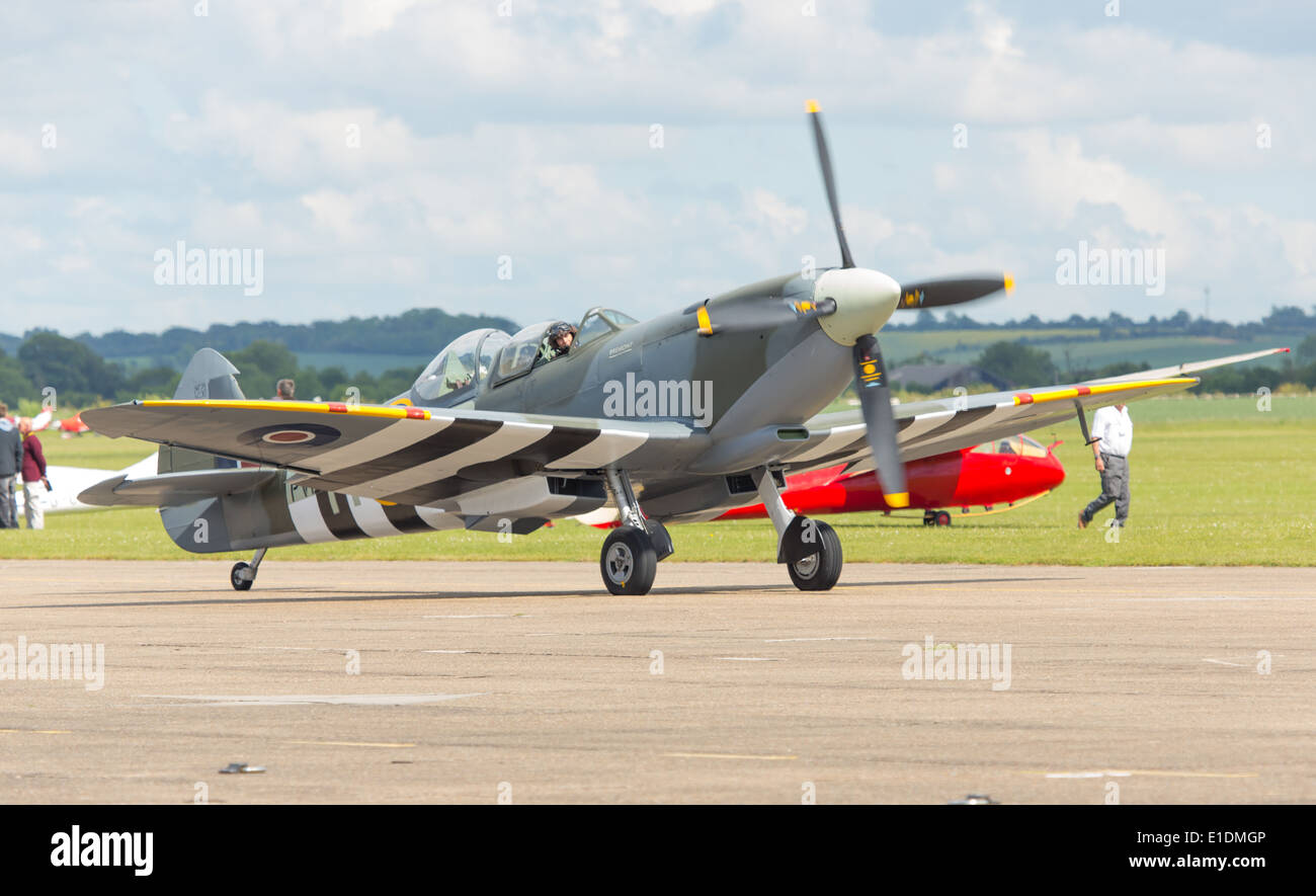 A World War II Spitfire fighter at Duxford Air Show in D-Day markings ...