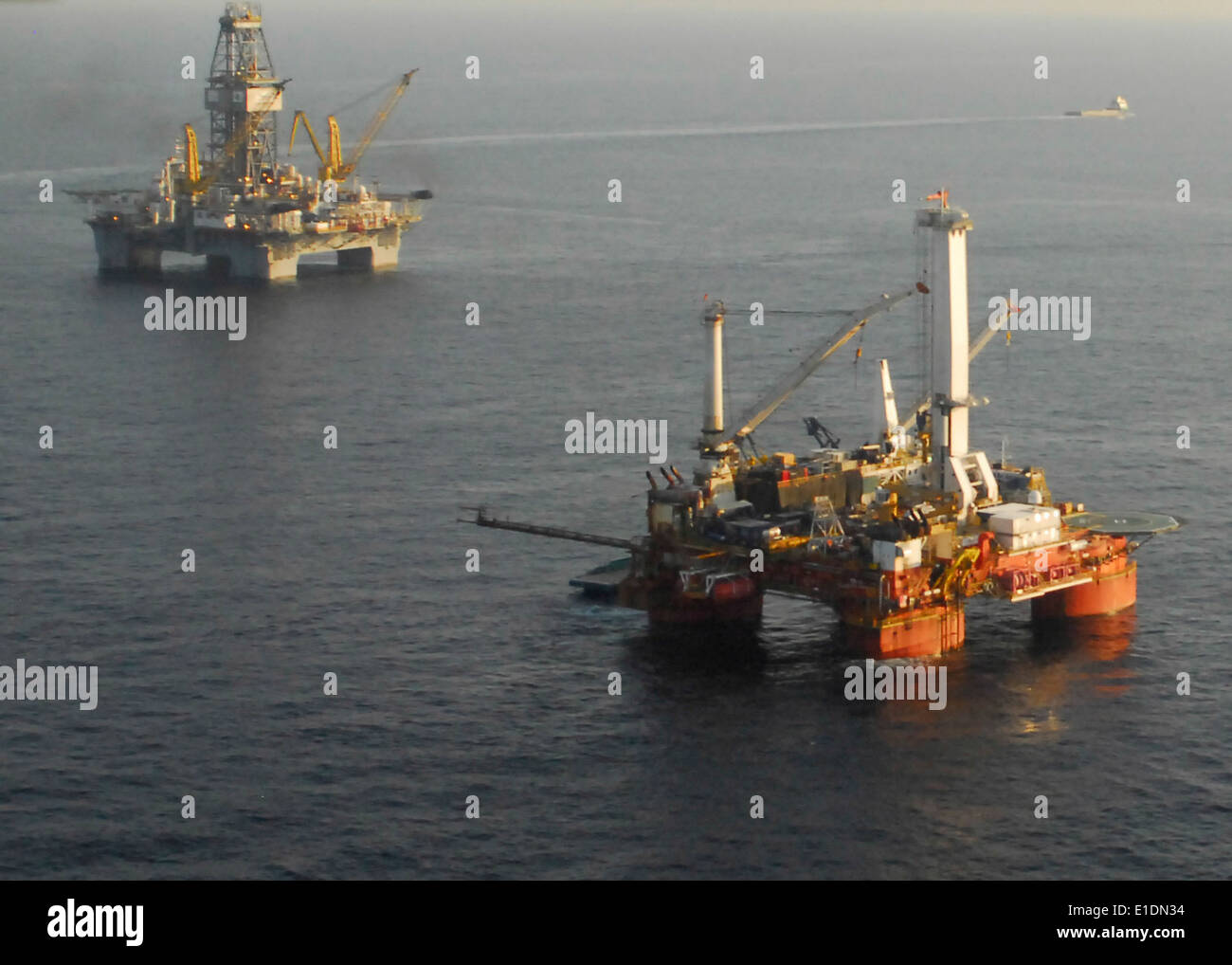 Rigs drilling a relief well and preparing the static kill are shown in ...