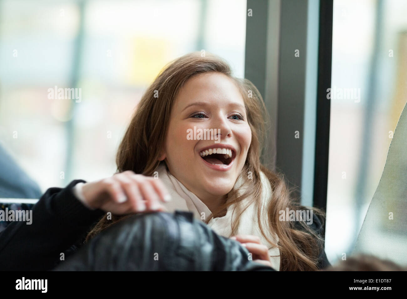Young Woman Laughing In Bus Stock Photo - Alamy