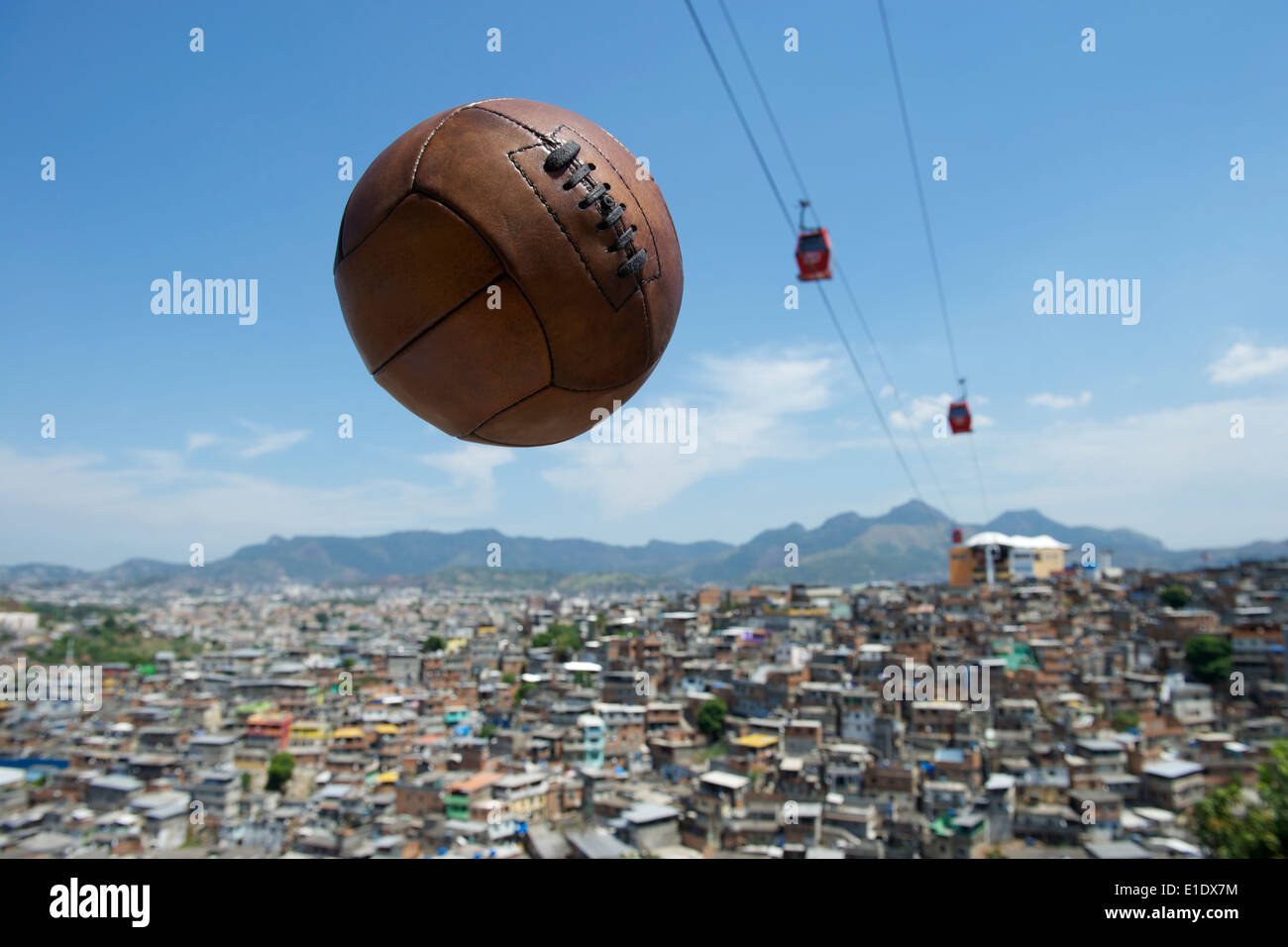 Vintage brown football soccer ball flying in the sky with red cable ...