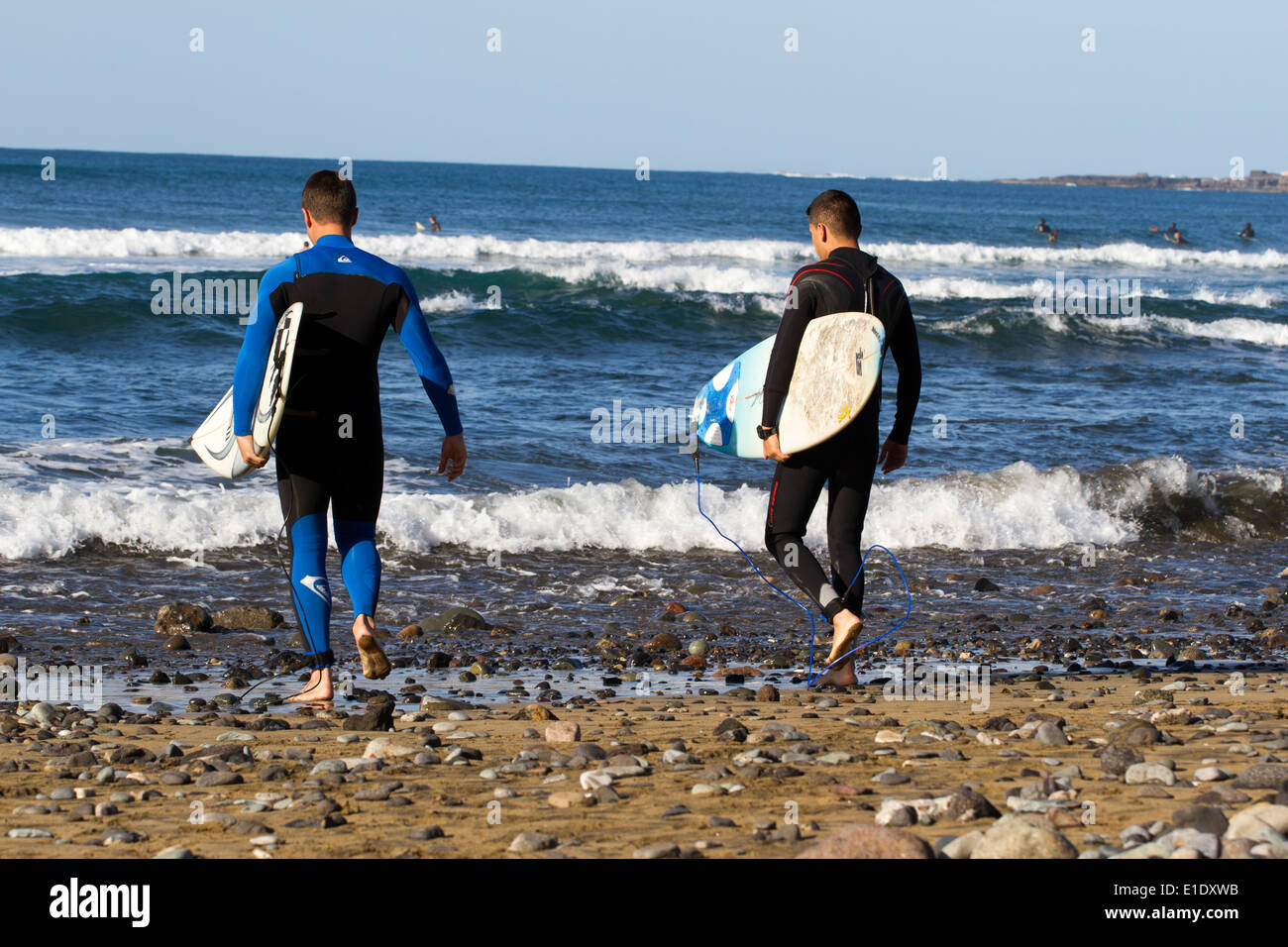 Surfers going for a surf Stock Photo - Alamy
