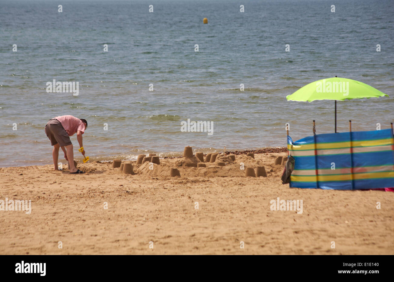 Man building sandcastles hi-res stock photography and images - Alamy