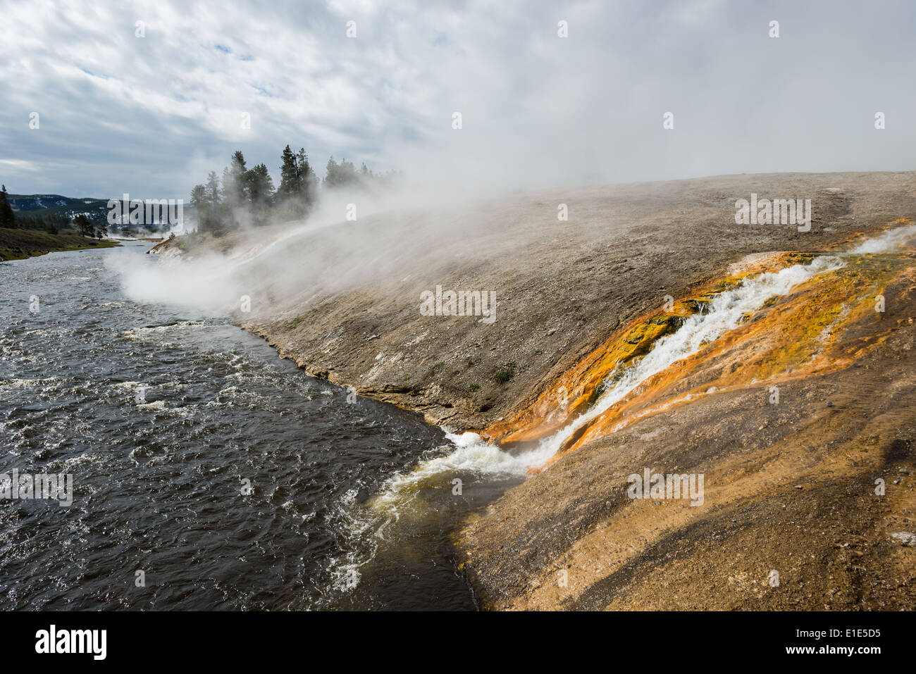 Steamy hot water from hot springs feeds into the Firehole River ...