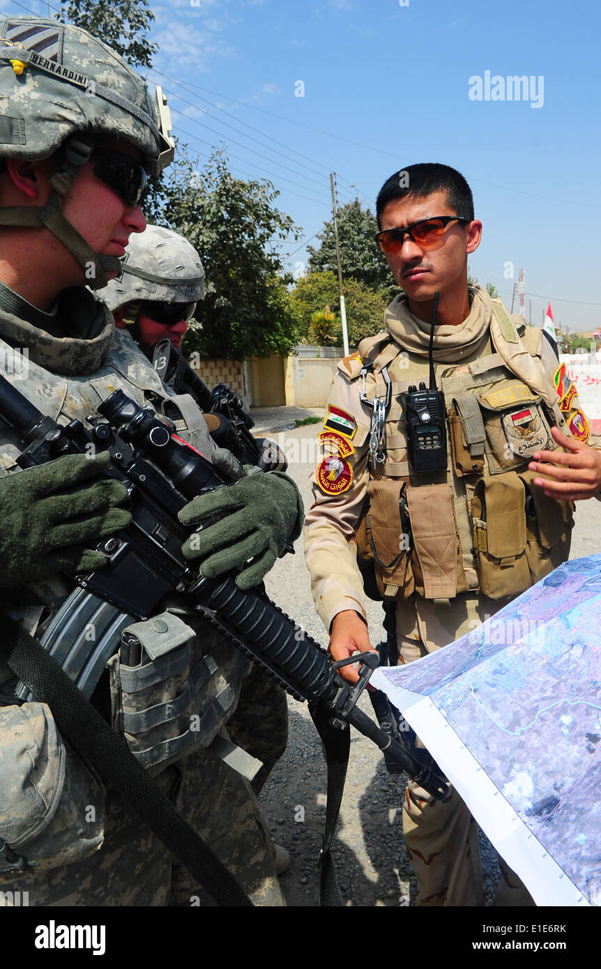 U.S. Army 2nd Lt. Alex Bernardini discusses a convoy route with an ...