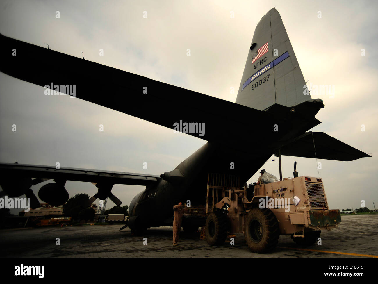 U.S. Airmen load supplies onto a C-130H Hercules aircraft from the ...