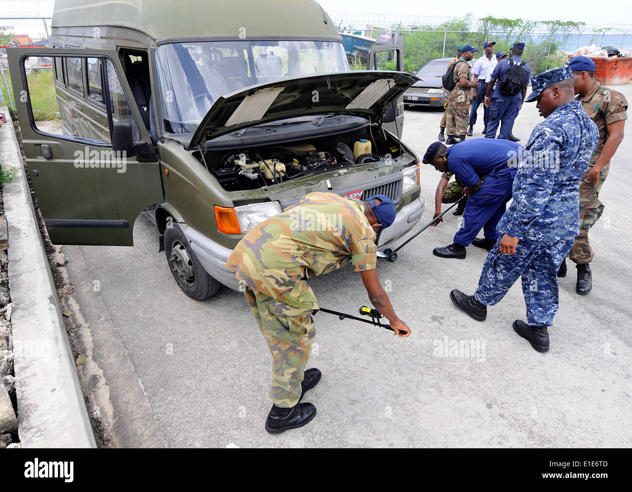 U.S. Navy Senior Chief Master-at-Arms Charles Mobley, right, observes ...