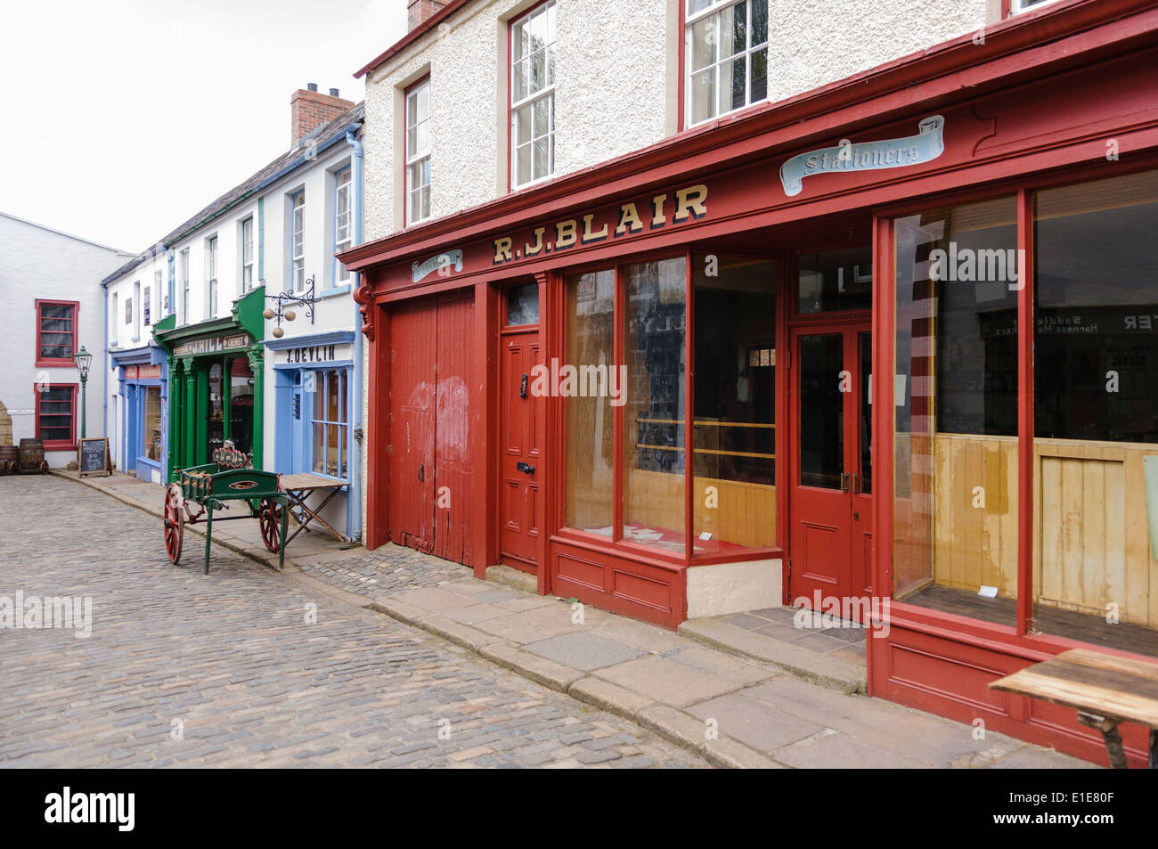 Old fashioned Irish cobbled high street and shops in the Ulster ...