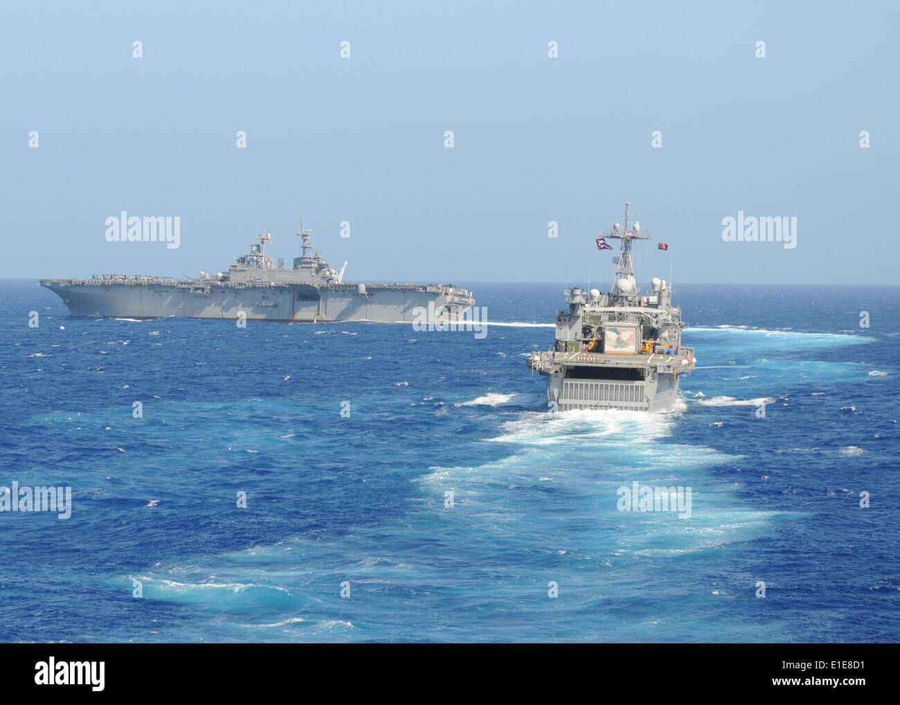 The amphibious assault ship USS Kearsarge (LHD 3), left, conducts a ...