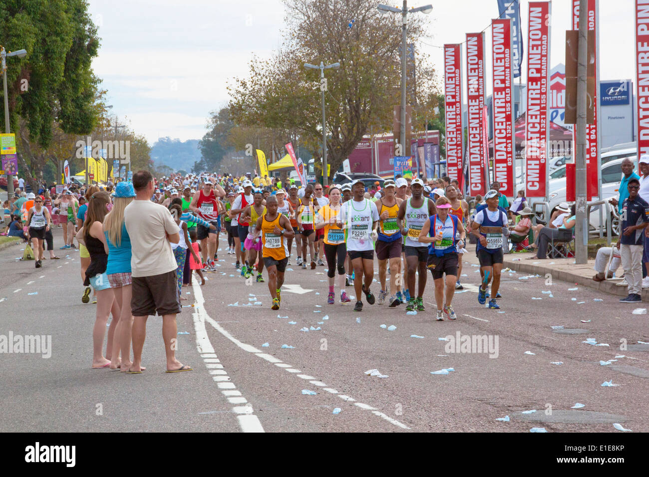 Spectators and Many runners competing in the long distance Comrades ...