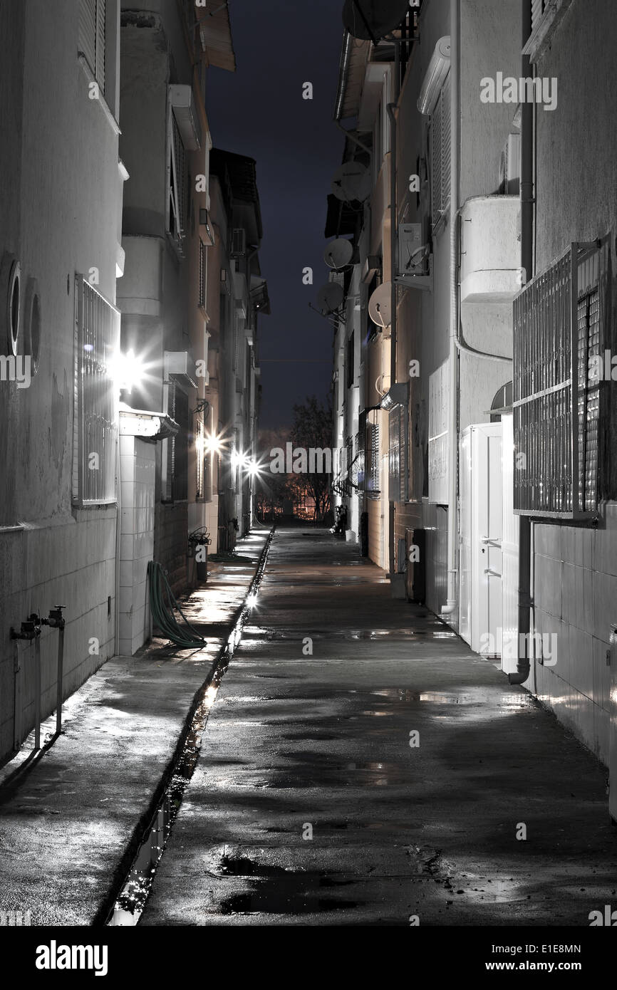 Dark wet empty alleyway at dawn Stock Photo - Alamy