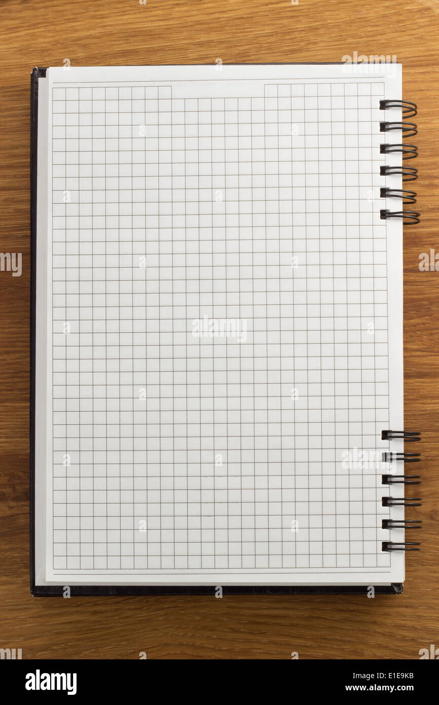 checked notebook on wood background Stock Photo - Alamy