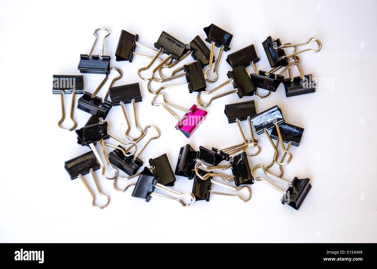 violet paper clip in black paper clip Stock Photo - Alamy