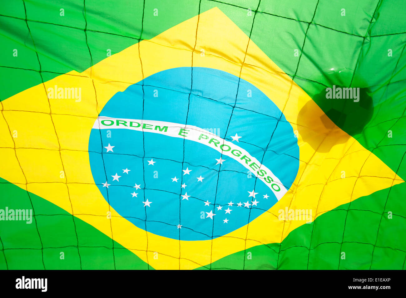 Football soccer ball flying into the goal net Brazilian flag background ...