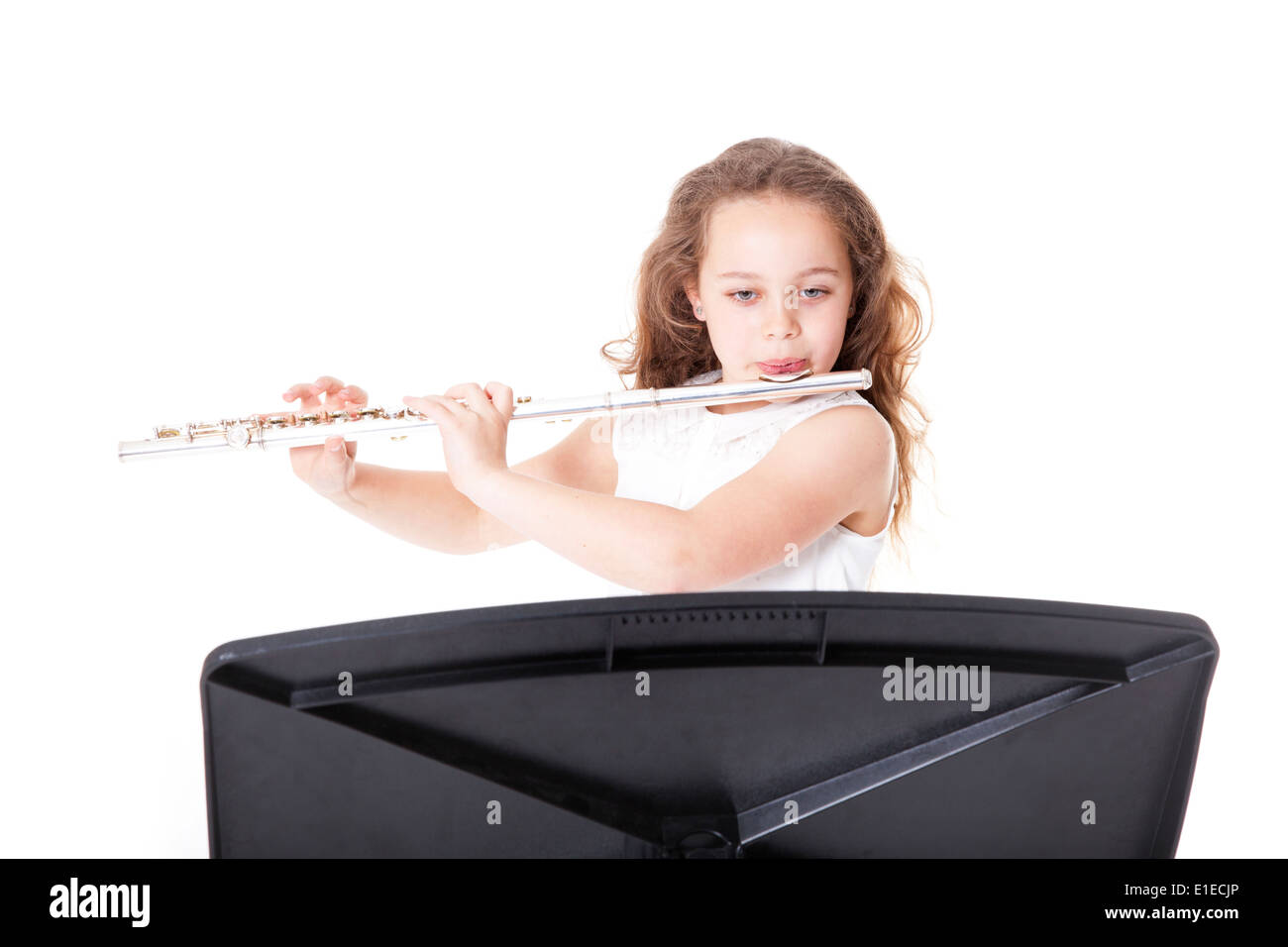 young girl playing flute against white background in studio Stock Photo ...