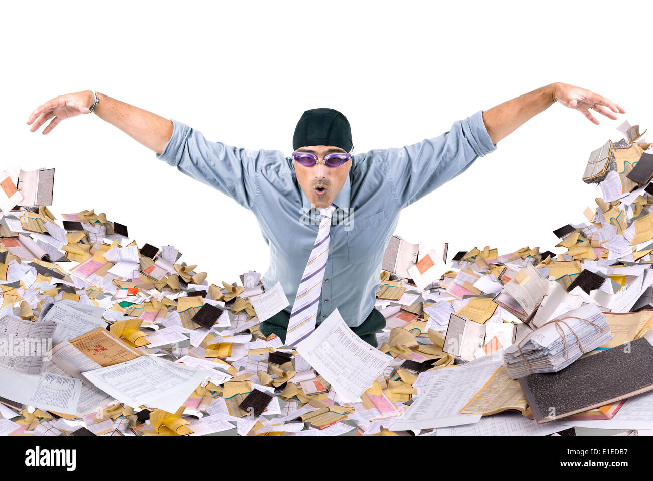 Businessman swimming in a sea of papers Stock Photo - Alamy