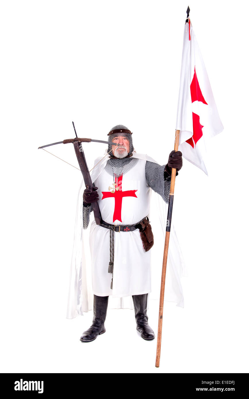 Knight Templar posing with crossbow and flag isolated in white Stock ...