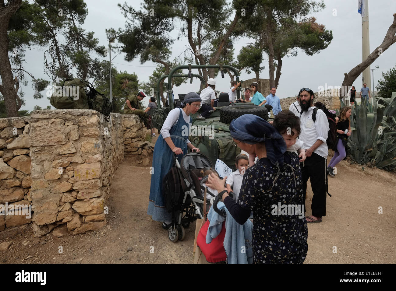 An Orthodox religious family at an army exhibition on Ammunition Hill ...