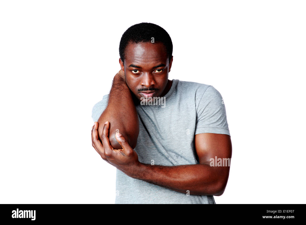 Portrait of african man holding his elbow over white background Stock ...