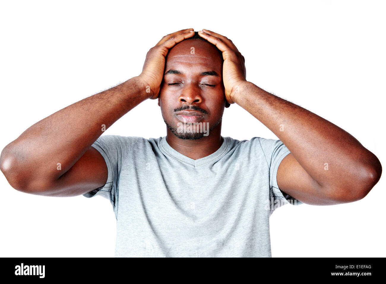 Portrait of African man touching his head over white background Stock ...