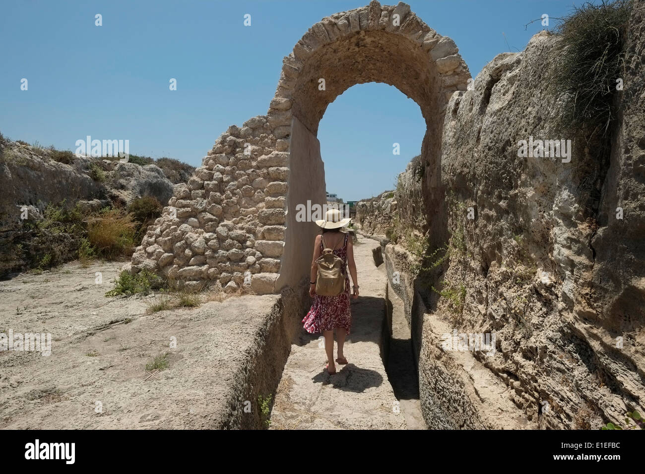 A female hiker hiking at the ancient Roman aqueduct at Nahal Taninim or ...