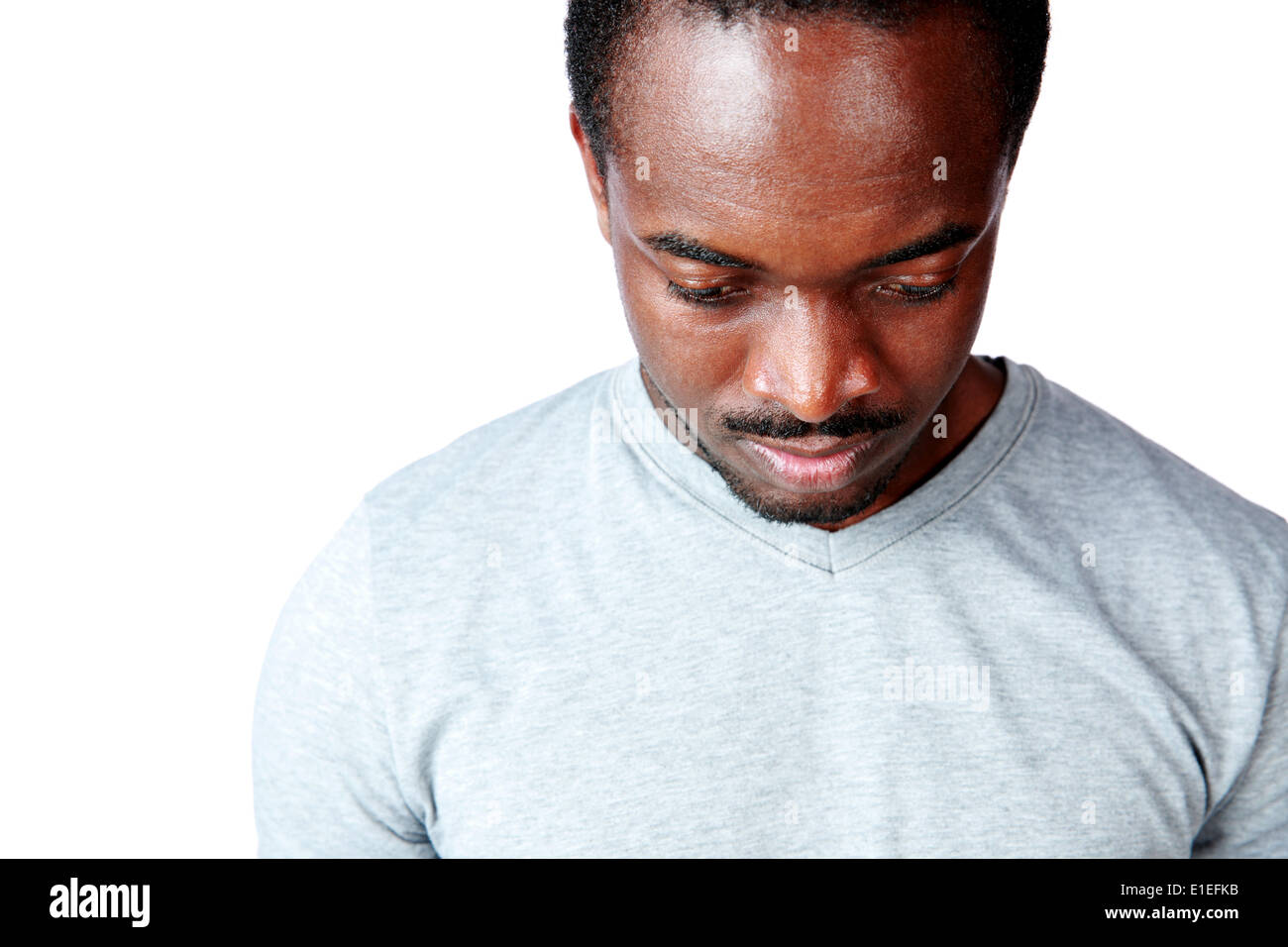 Portrait of a pensive african man looking down Stock Photo - Alamy