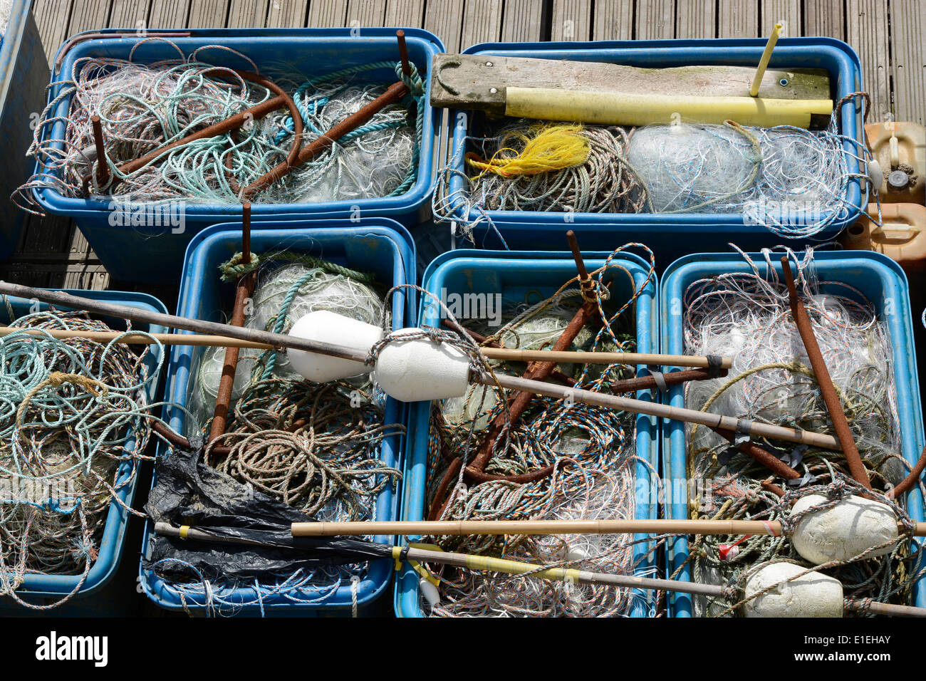 Boxes of fishing equipment, lines, nets, floats, tackle on pontoon at ...