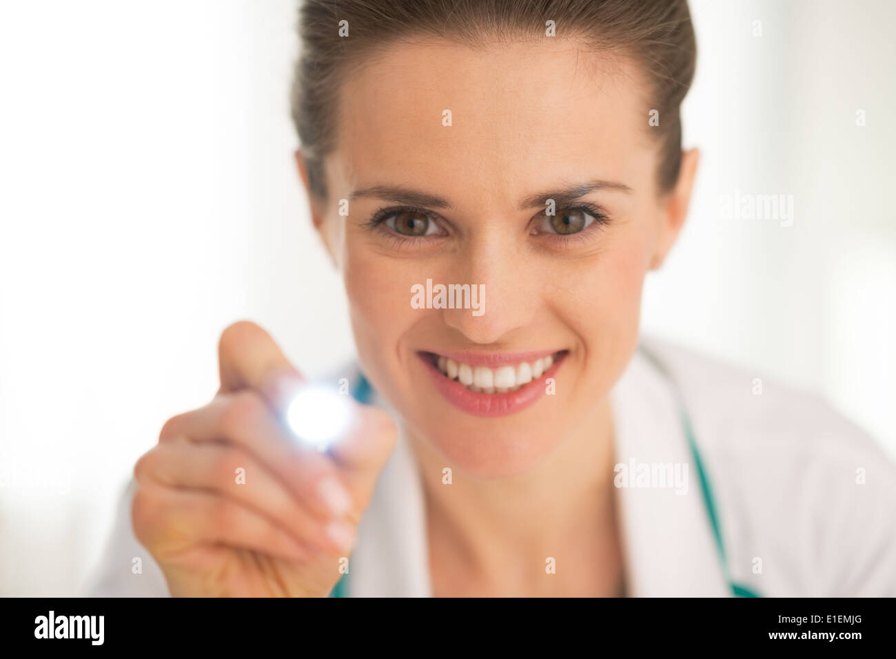 Medical doctor woman examining with flashlight Stock Photo - Alamy