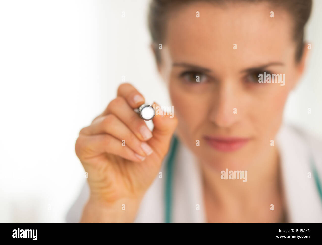 Closeup on medical doctor woman examining using flashlight Stock Photo ...