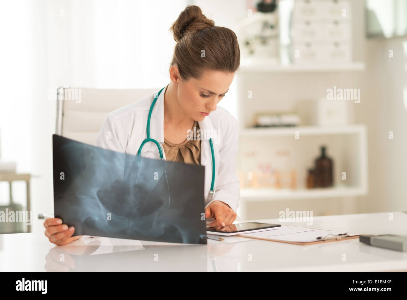 Medical doctor woman with fluorography working in office Stock Photo ...