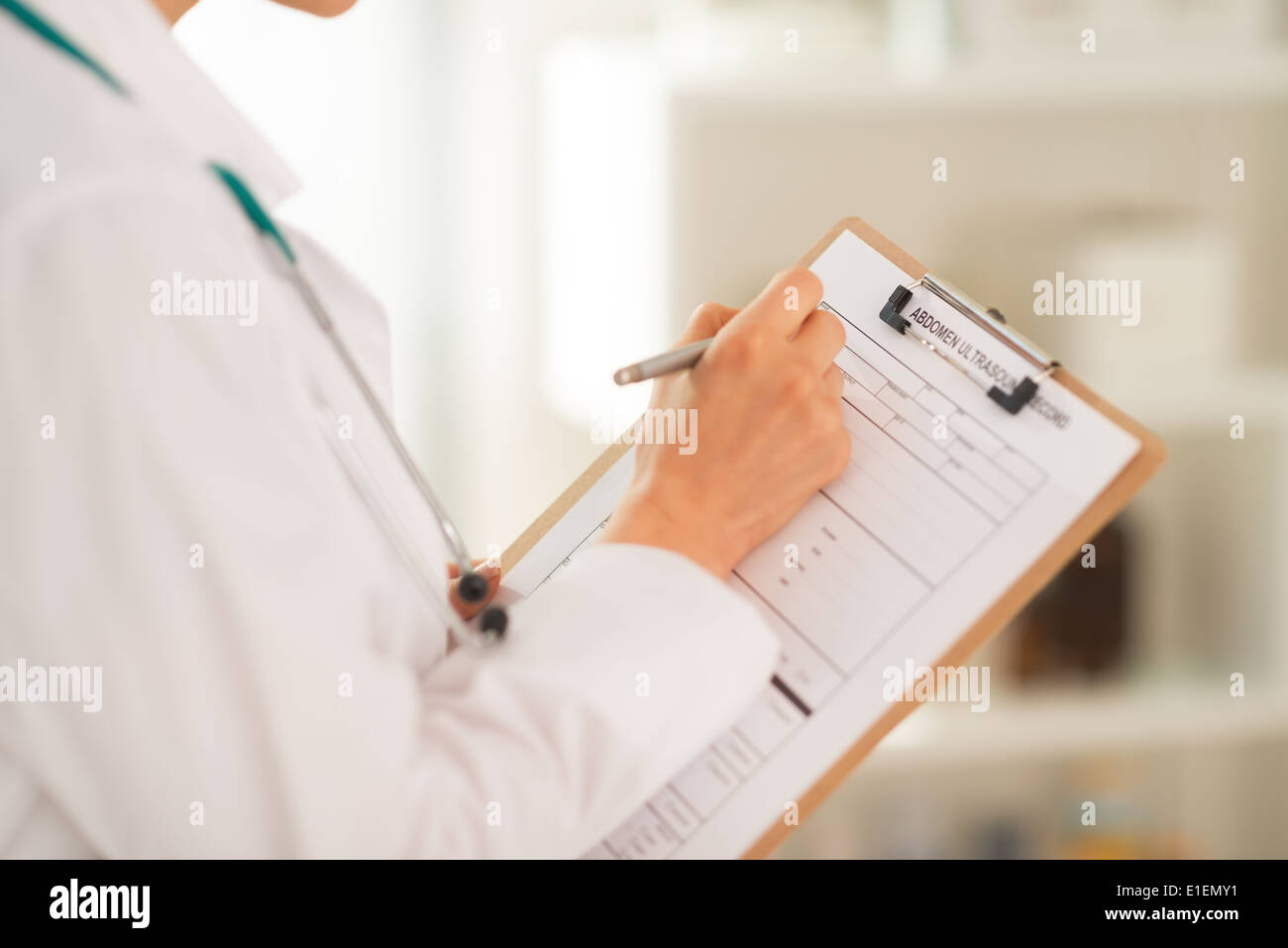 Closeup on medical doctor woman writing in clipboard Stock Photo - Alamy
