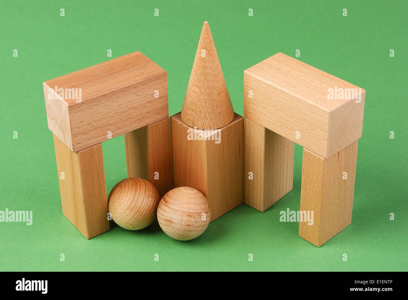 wooden geometric shapes on a green background Stock Photo - Alamy