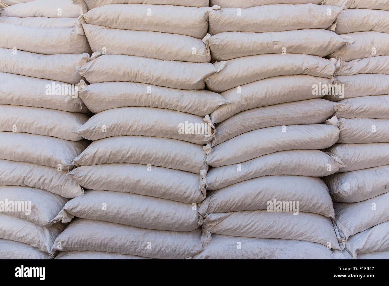 Pile sacks in warehouse Stock Photo - Alamy