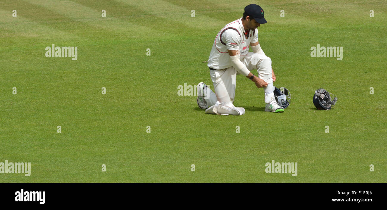 a fielder put on leg pads before fielding close to the bat in a cricket ...