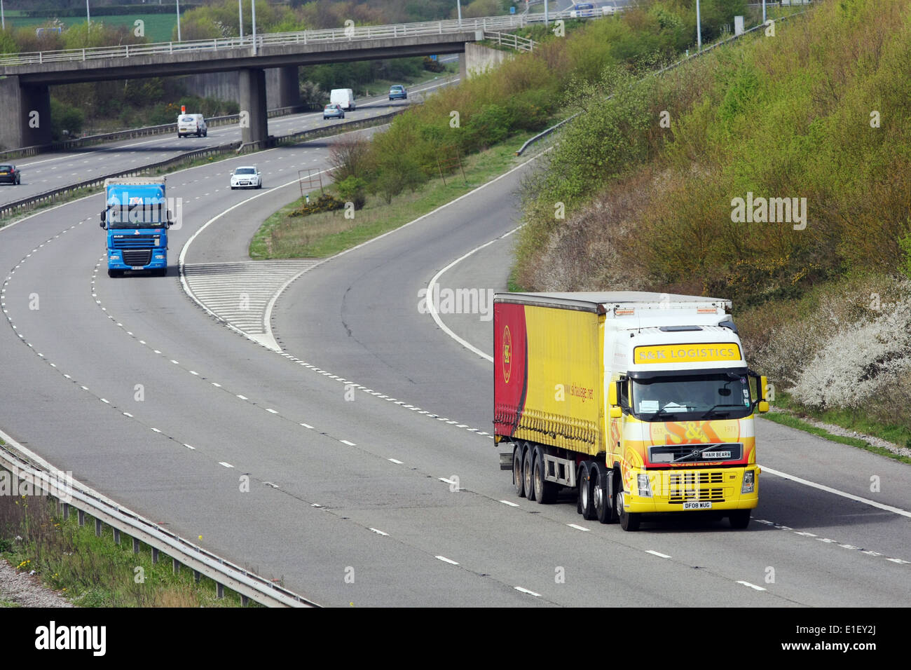 A few trucks and cars traveling along the M20 motorway in Kent, England ...