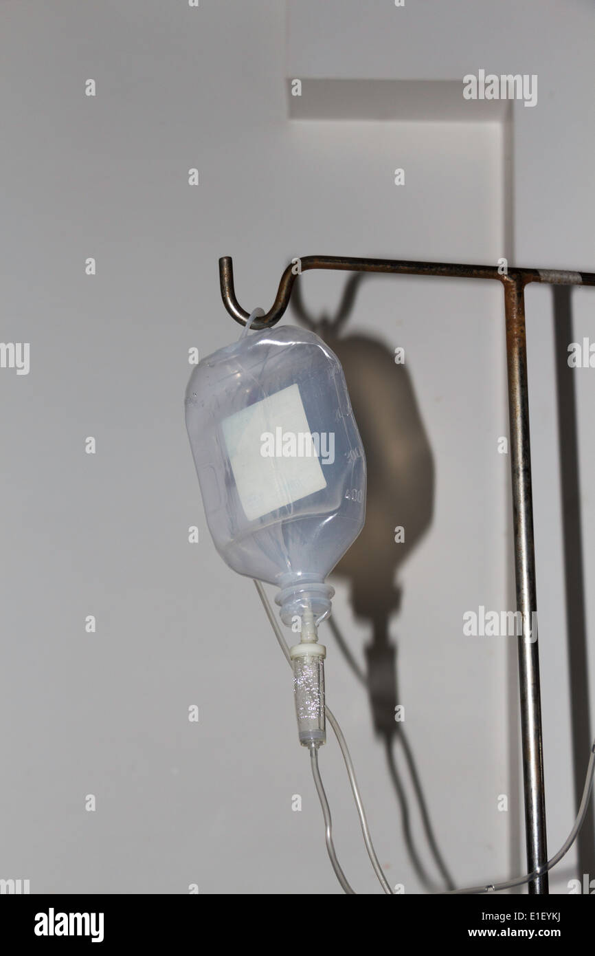 An empty glucose bottle on a stand inside a hospital room, used for ...