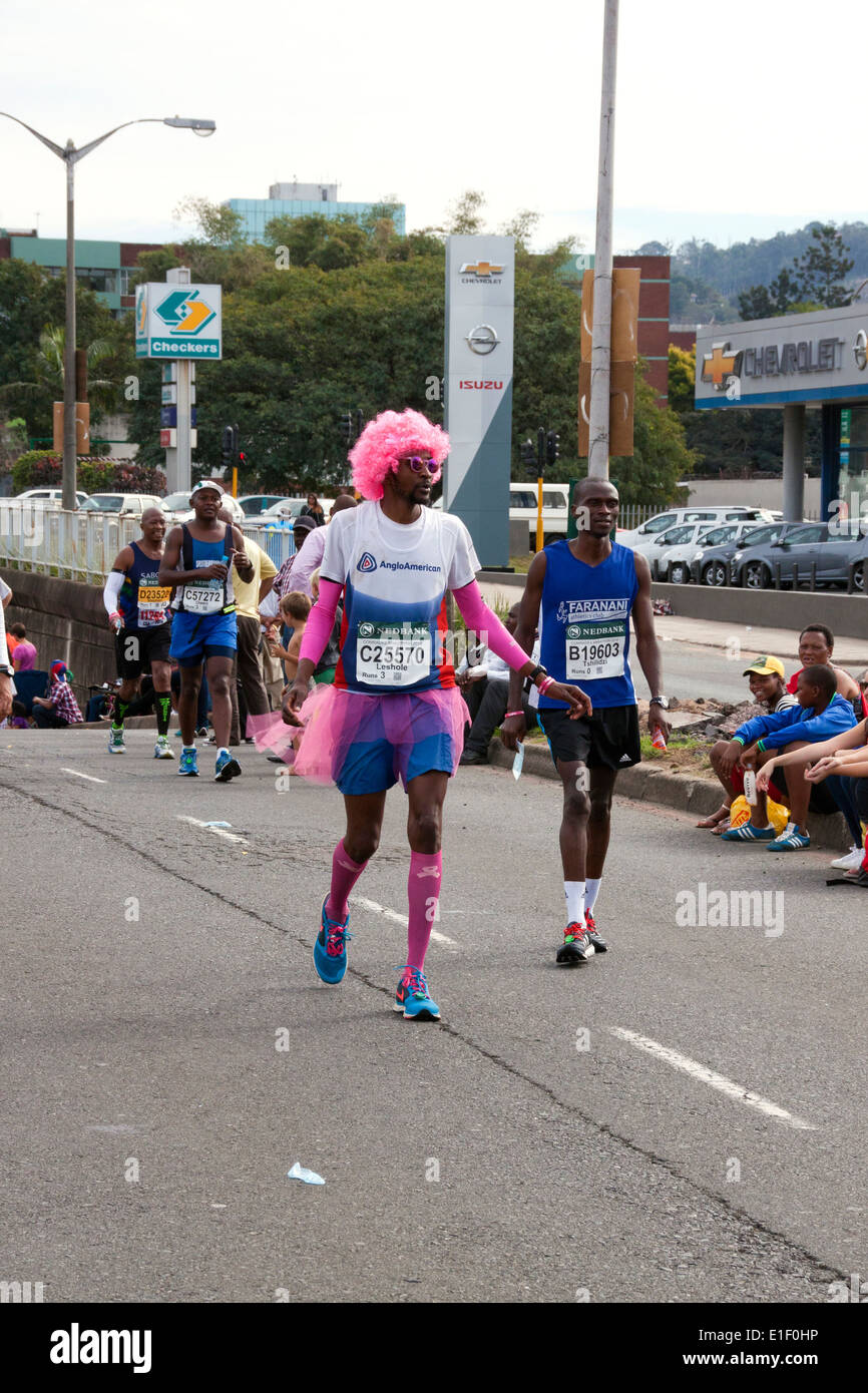 Colorful runners competing in the long distance Comrades Ultra Marathon ...
