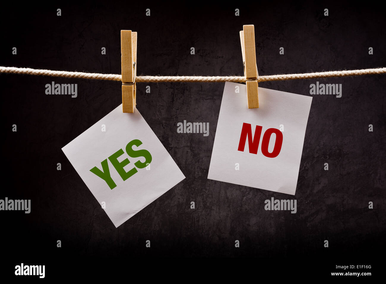 Yes and No printed on message note paper, hanging on the rope Stock ...