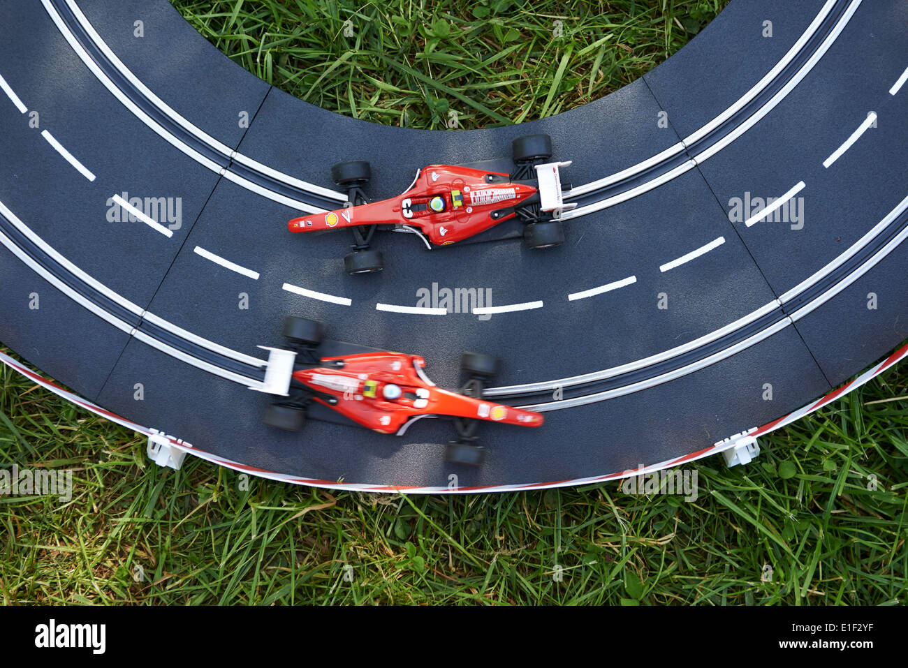 playing with racetrack outside in green lawn, garden, summer, formula 1 ...