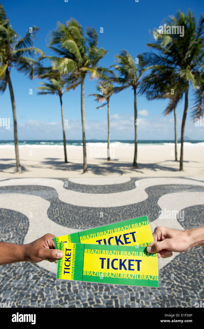 Hands holding pair of tickets to football soccer event in Copacabana ...