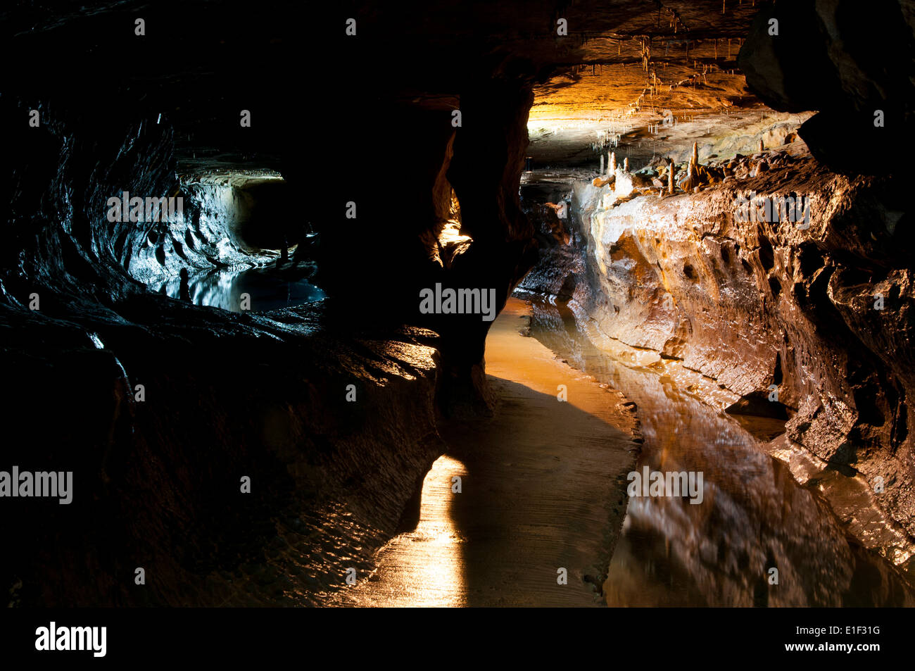 A stream meandering past stalactite and stalagmite limestone rock ...