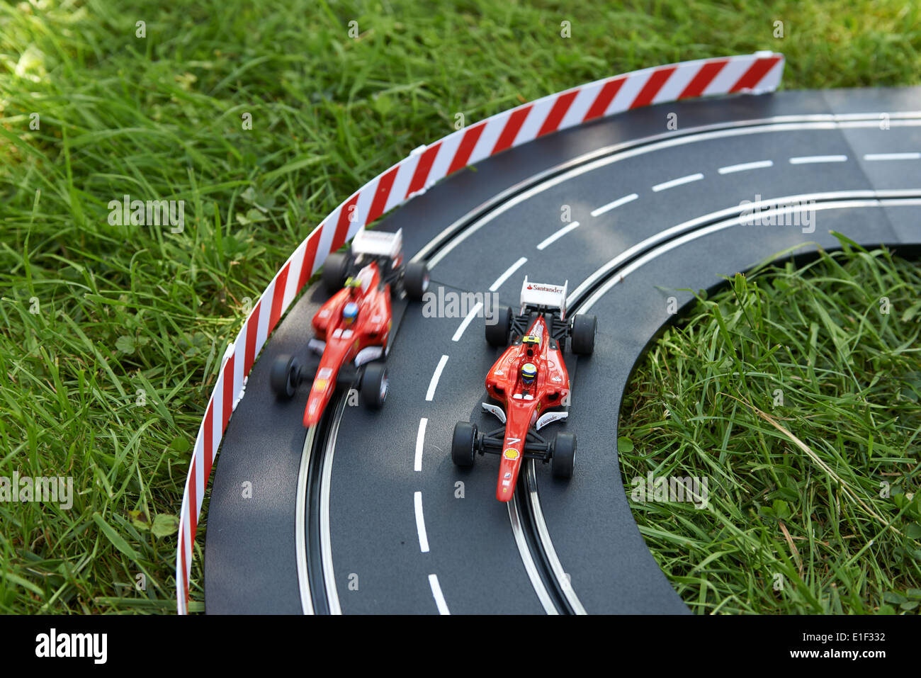 playing with racetrack outside in green lawn, garden, summer, formula 1 ...