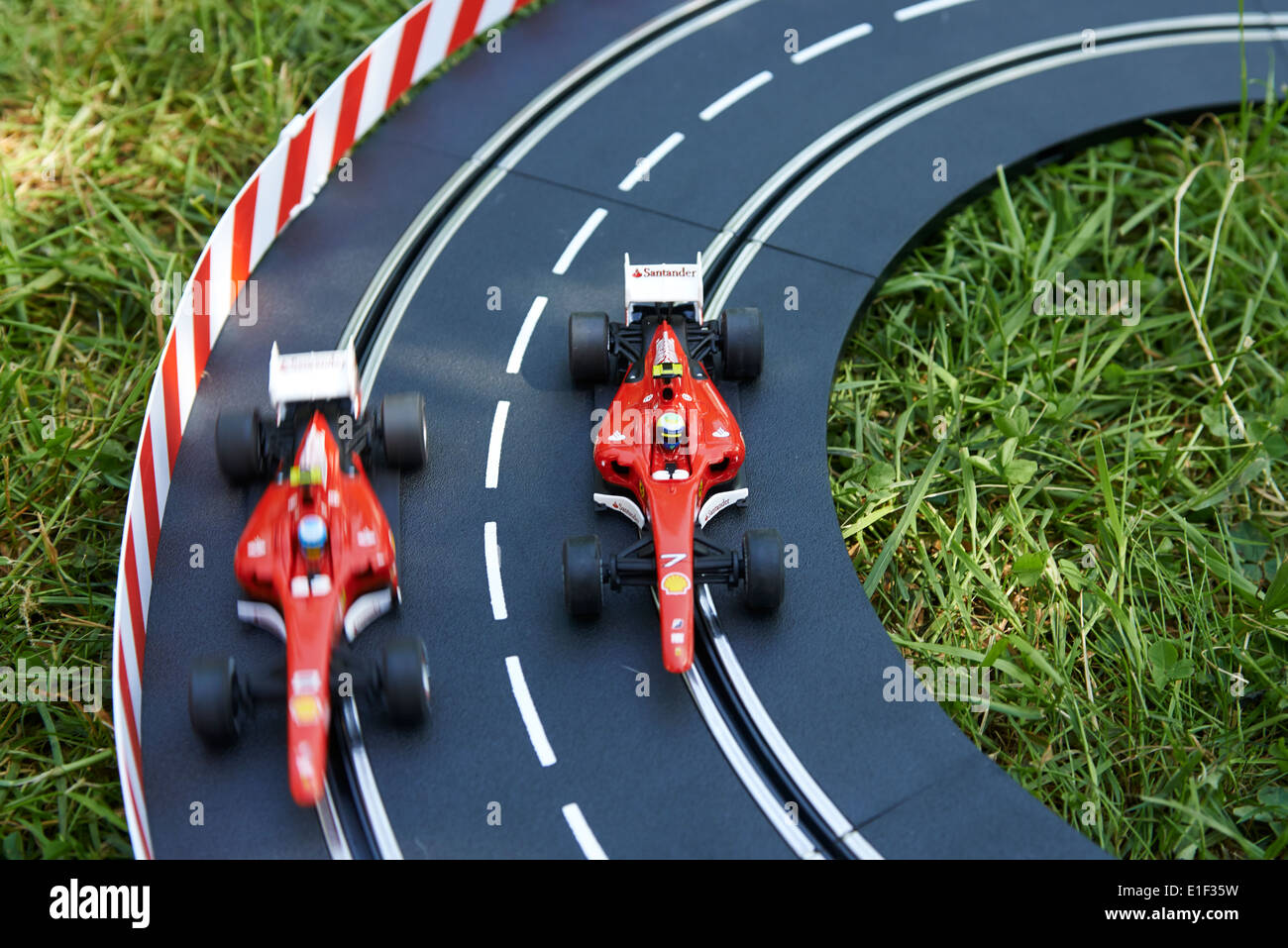 playing with racetrack outside in green lawn, garden, summer, formula 1 ...