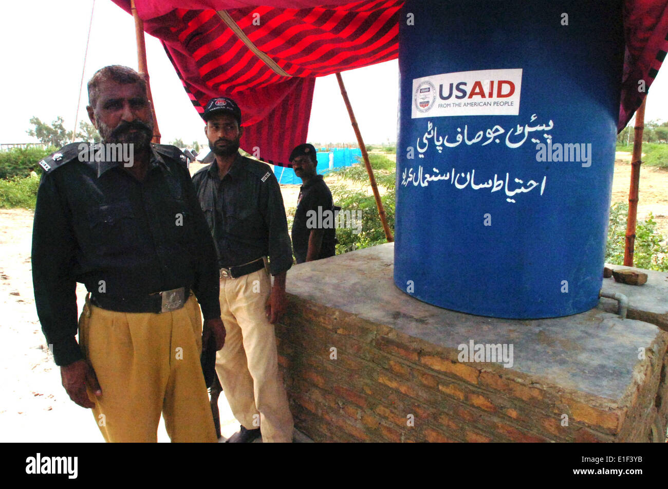 Pakistani security officers guard a settlement for internally displaced ...