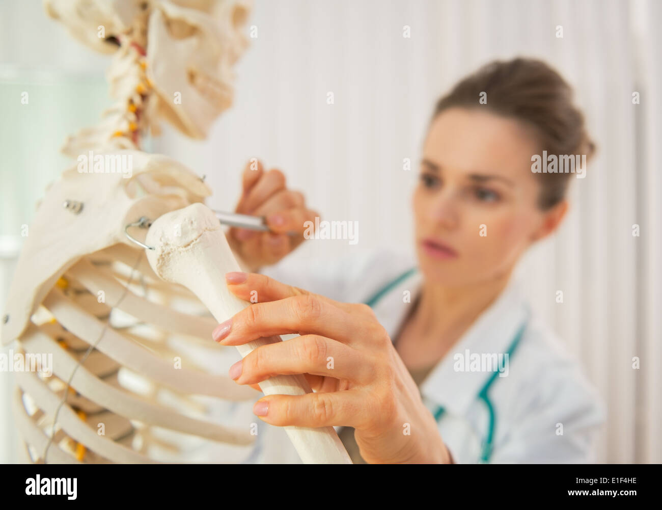 Closeup on medical doctor woman teaching anatomy using human skeleton ...