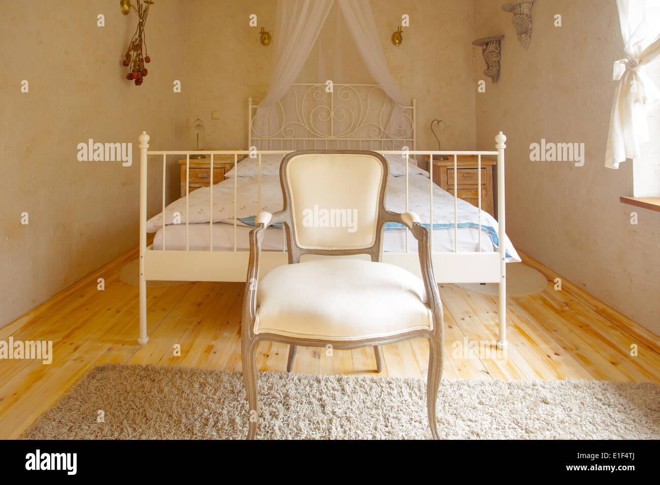 Interior of nice bedroom in vintage rural style. Room with comfortable ...