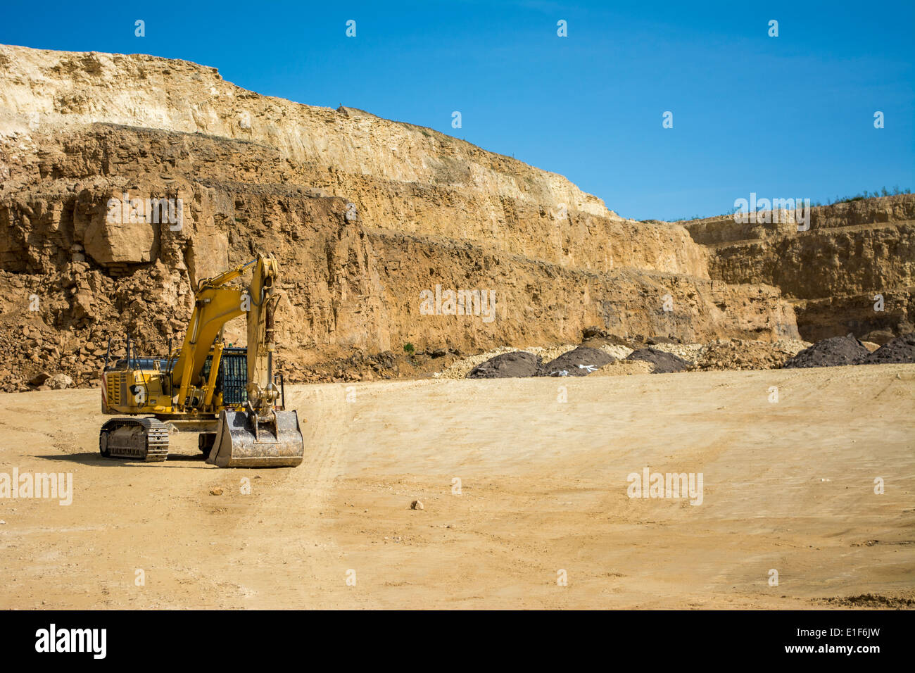 Excavator at quarry mining site Stock Photo - Alamy