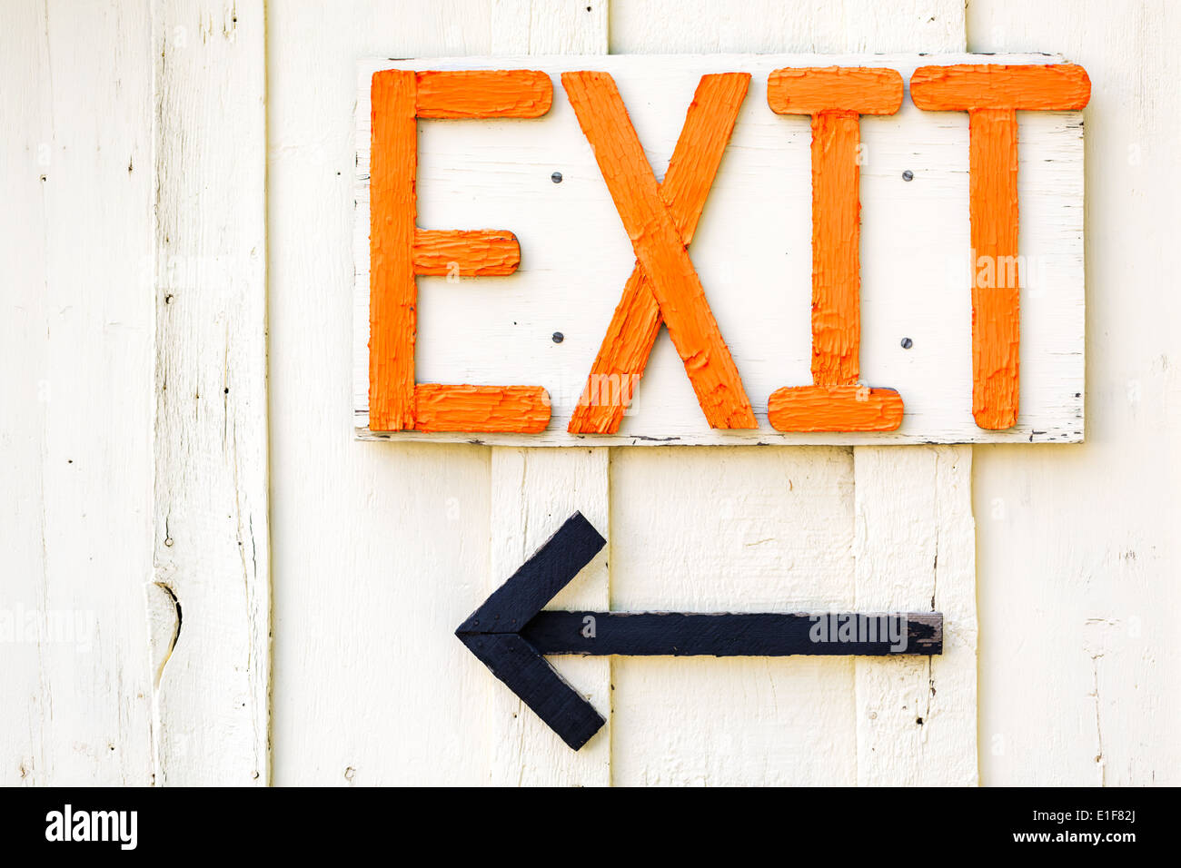 Painted exit sign on white siding Stock Photo - Alamy