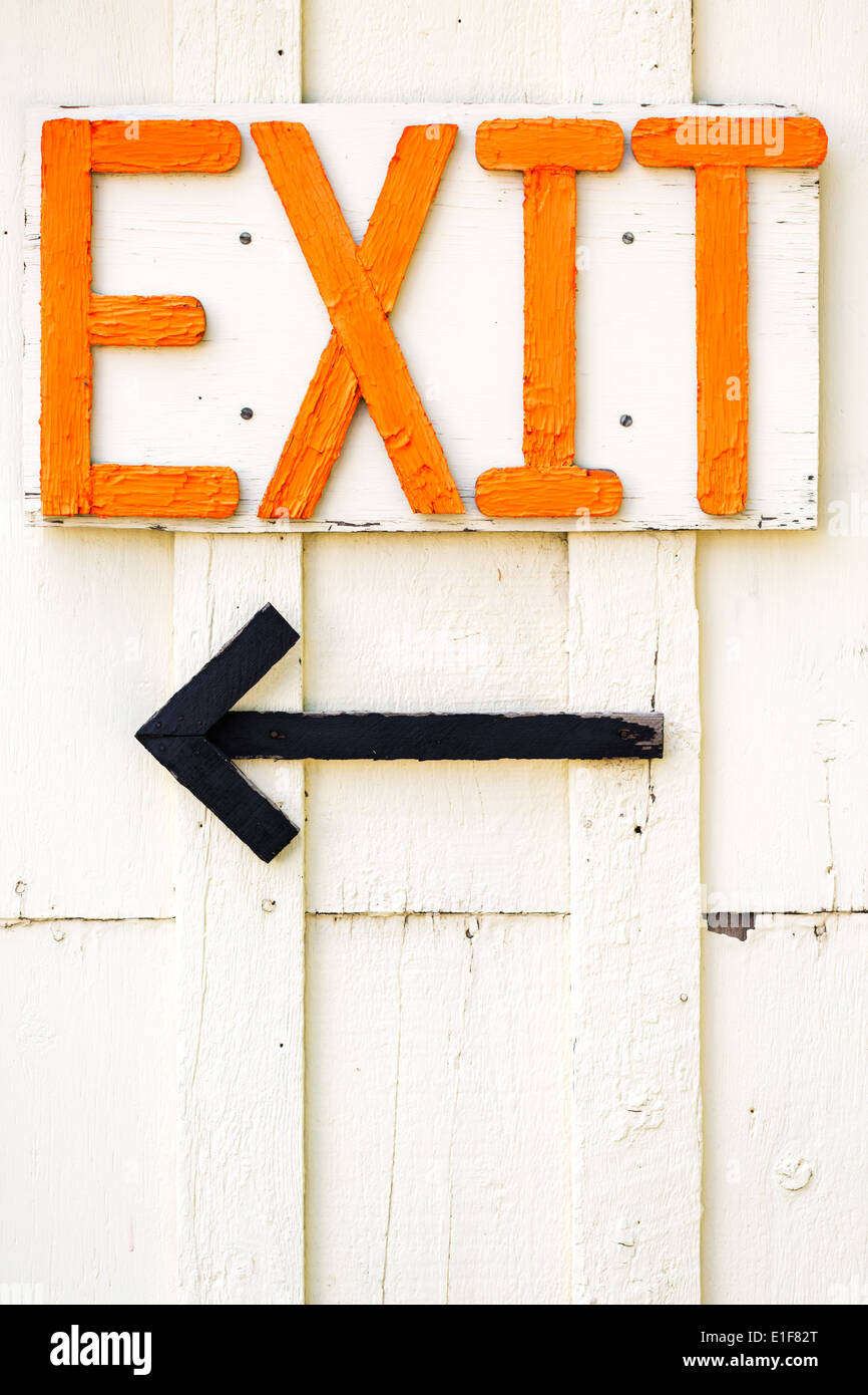 Painted exit sign on white siding Stock Photo - Alamy