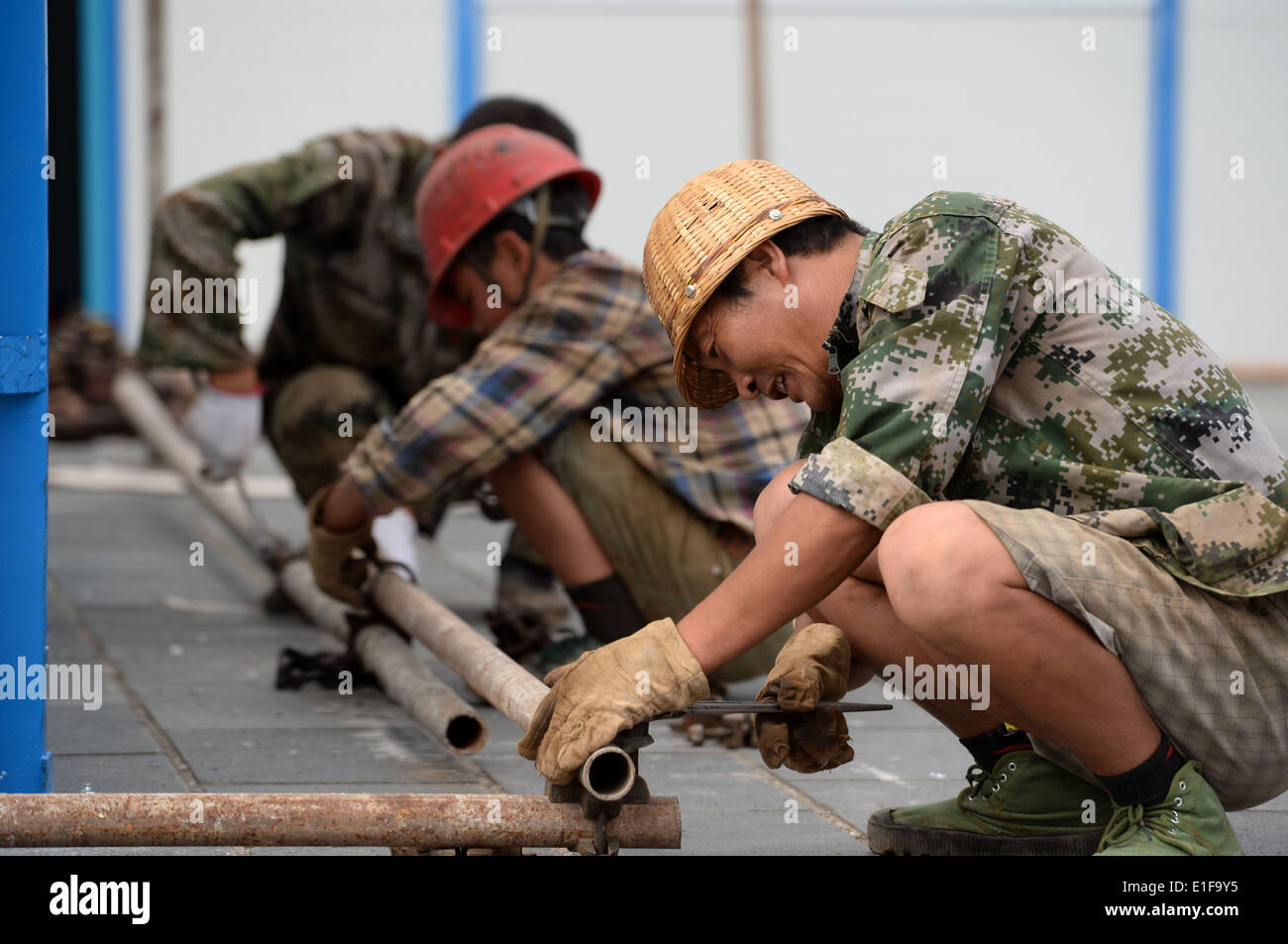 Yingjiang, China's Yunnan Province. 2nd June, 2014. Workers set up ...