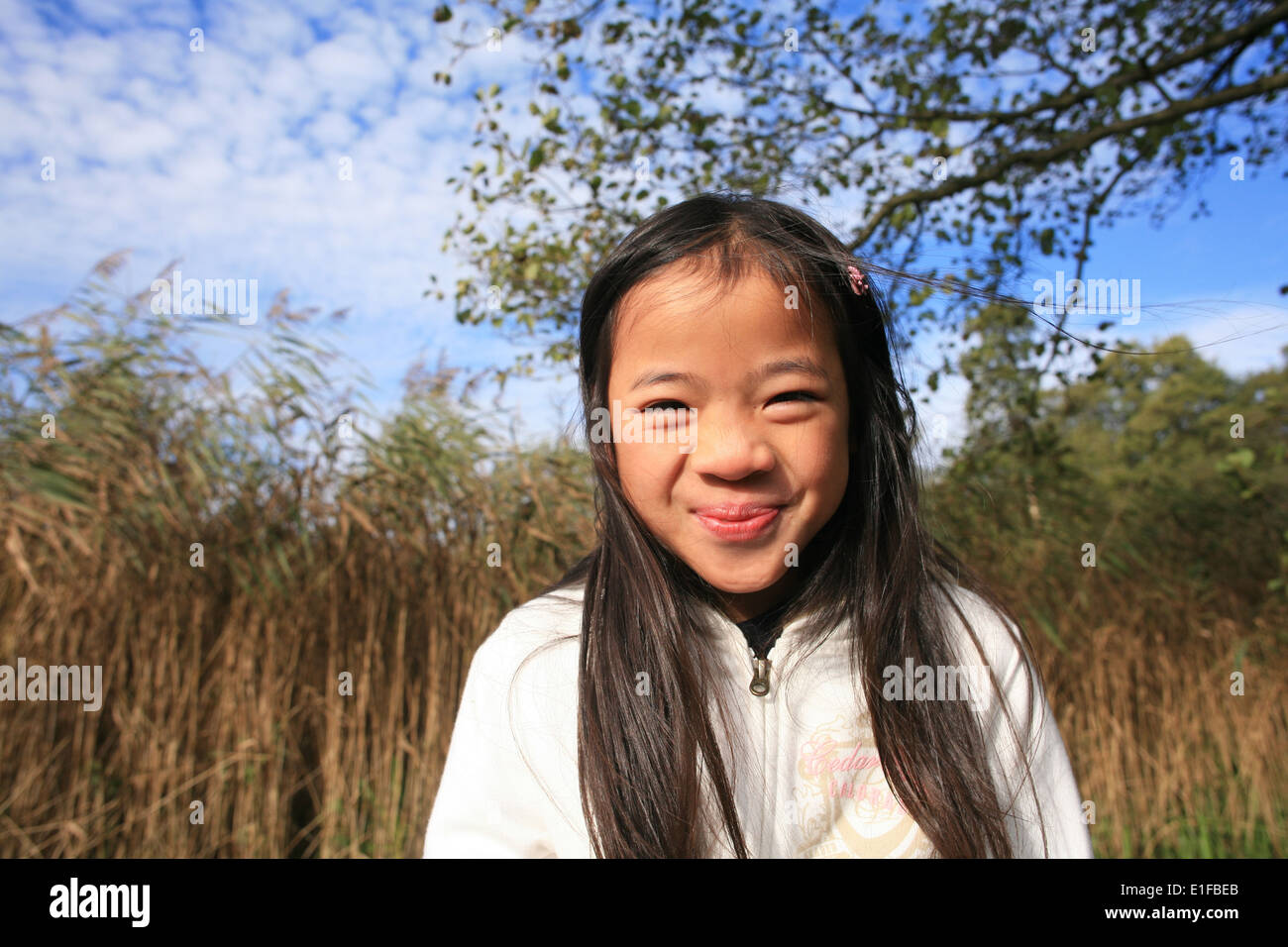 Cute chinese child portrait outdoor in the sunshine Stock Photo - Alamy